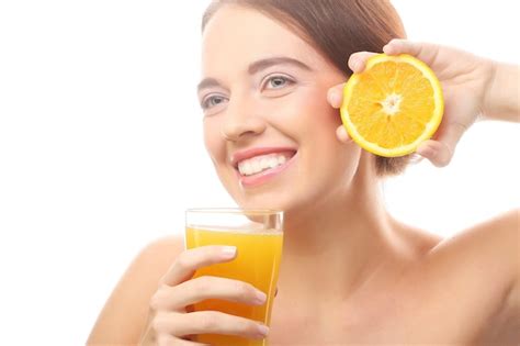 Premium Photo | Young happy woman drinking orange juice