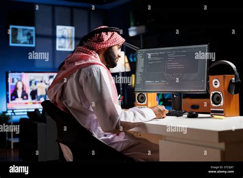 Dedicated Software Programmer Wearing Traditional Arabic Clothing Is