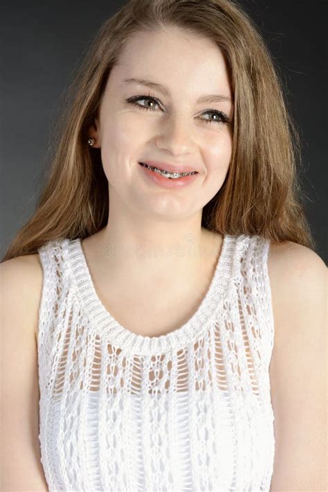 Portrait Of A Happy Smiling Teenage Girl With Braces In The Studio Stock Image Image Of Plait