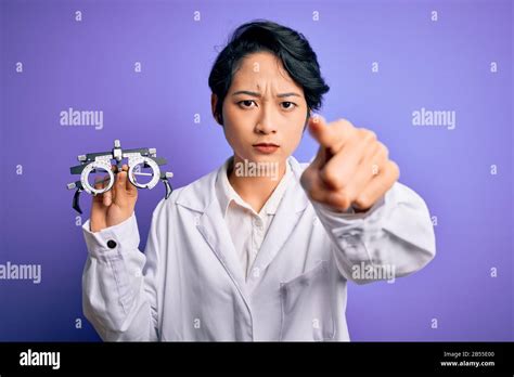 Beautiful Asian Optical Girl Wearing Coat Holding Optometry Glasses