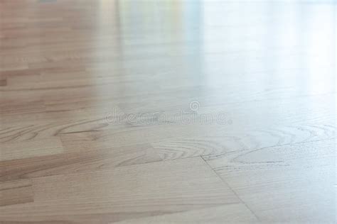 wooden parquet or laminate floor surface with light reflection on