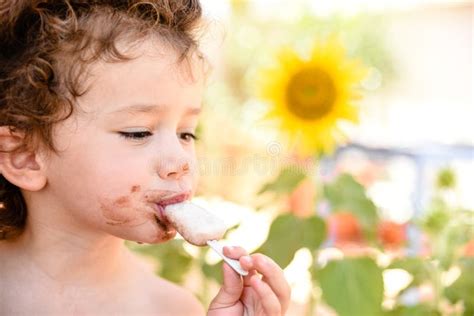 Young And Adorable Two Year Old Girl Sucks An Ice Cream Sundae Melted
