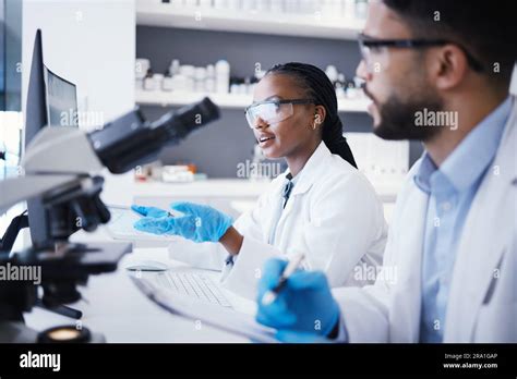 Scientist Man Woman And Checklist In Laboratory With Microscope Pc Or Analysis For Virus Dna