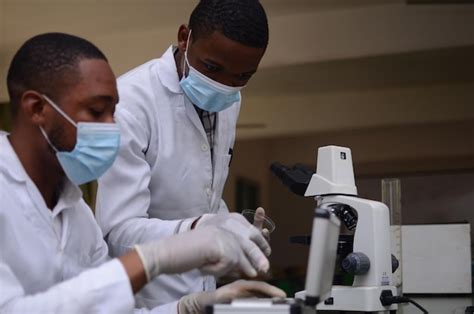 Premium Photo Scientist Microbiologists With Uniforms Working With