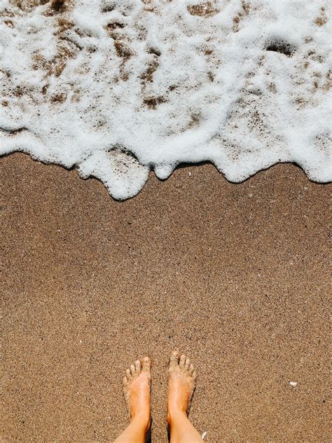 Premium Photo Woman Legs Barefoot At Sea Foam Waves On Sand Beach