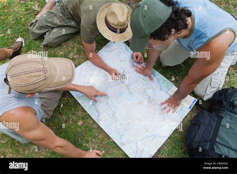 Hikers Using Compass And Looking At Map Together High Angle View Stock