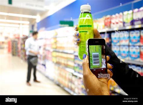Shopping Using A Smart Phone To Scan Barcodes Of Consumer Goods In A