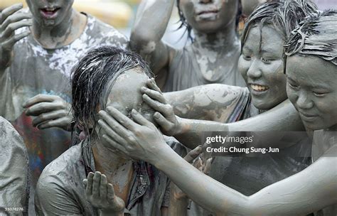 Participants Enjoy The Mud On The West Coast Beach During The News