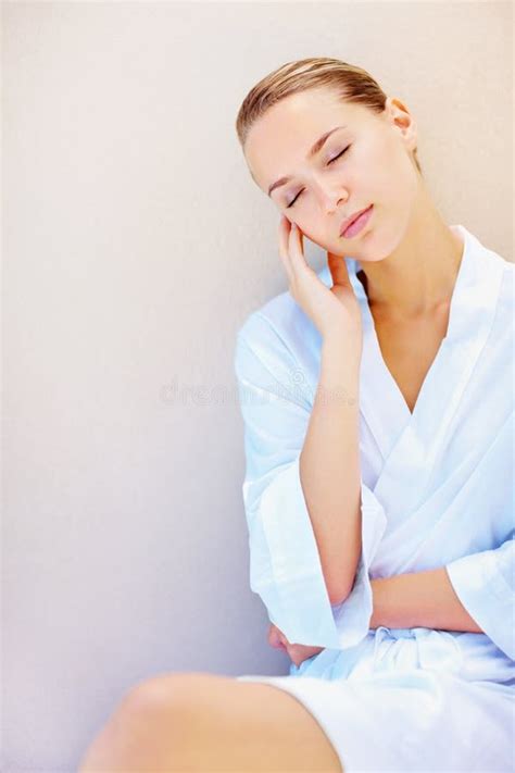 Female In A Bathrobe Fallen Asleep Against A Wall Cute Young Woman In A Bathrobe Fallen Asleep