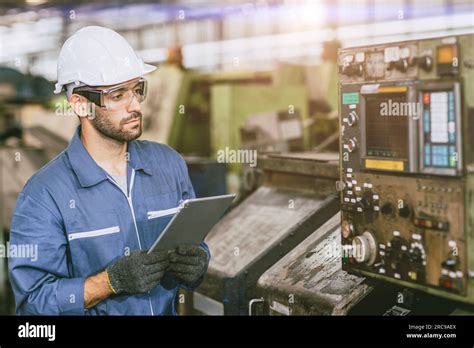 Hispanic Latin Indian Male Worker Working Control Operate Lathe Cnc Machine In Heavy Metal Steel