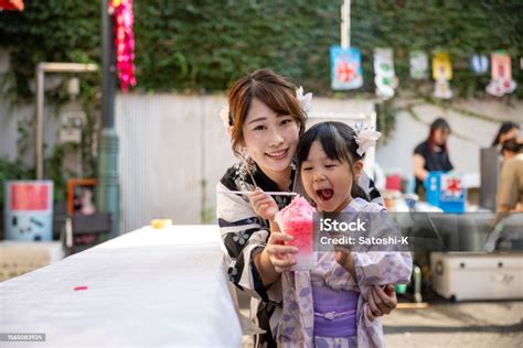 Portrait Of Mother And Daughter In Yukata Eating Kakigori Shaved Ice In