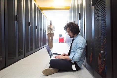 Premium Photo Team Of Young Technicians Working Together On Servers At The Data Center Using