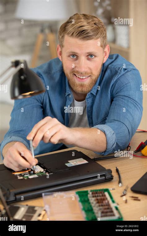 Happy Man Fixing Computer Laptop Tr Stock Photo Alamy
