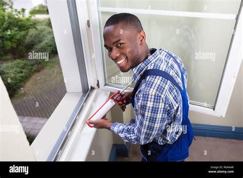Male Worker Applying Silicone Sealant Stock Photo Alamy