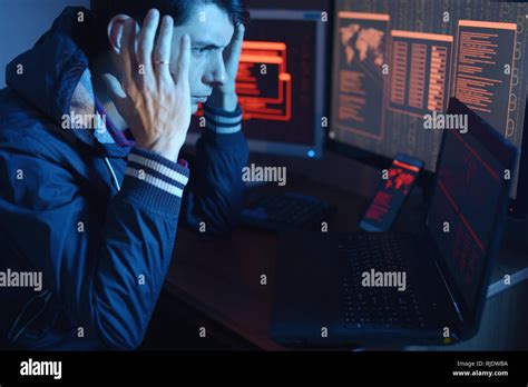 a male hacker thinking about the problem of hacking or malware