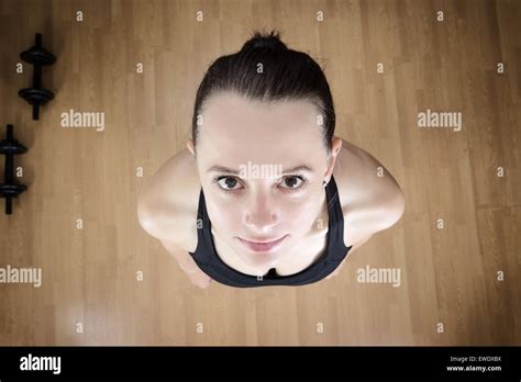 Fitness Woman Looking Up At Camera At A High View Point Above The Model