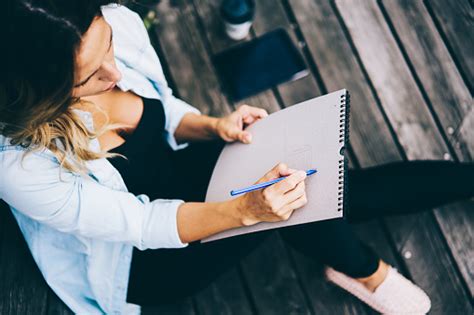 도시 에 앉아있는 동안 코스 작업 프로젝트 및 기록 정보를 준비하는 재능있는 여학생의 최고보기 거리에서 교과서에 몇 가지 표기술