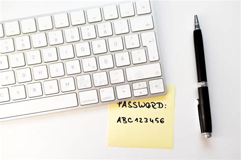 Top Down View Of Yellow Adhesive Note With Unsafe Password Under