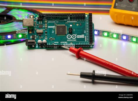 Arduino Mega Displayed With LED Strip Multimeter And Jumper Wire Background Stock Photo