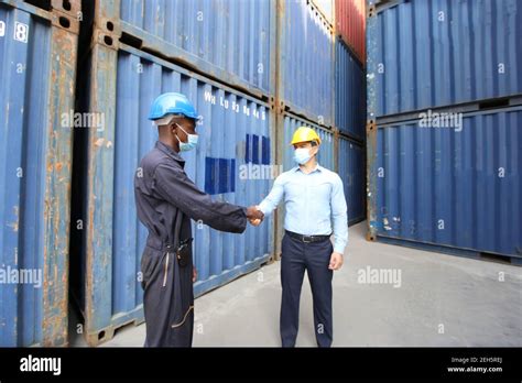Engineer Or Supervisor Checking And Control Loading Containers Box From Cargo At Harbor Foreman