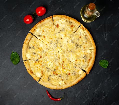 Four Cheese Pizza With Different Types Of Cheese On A Stone Background