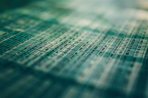 Detailed View Of A Table Covered In Rows Of Numbers And Formulas