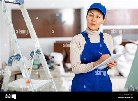 Female Engineer Matching Check List During Repair Works Stock Photo Alamy