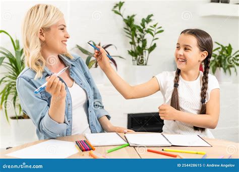 Mother And Daughter Spending Time Together At Home Drawing Stock Image