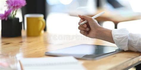 Close Up Woman Holding A Stylus Pen While Sitting In Front Her Computer Tablet And Notebook