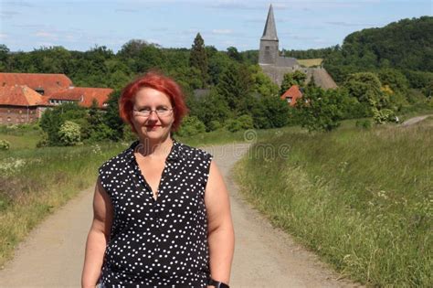 Outdoor Portrait Of A Beautiful Redhead Woman While Walking Stock Image