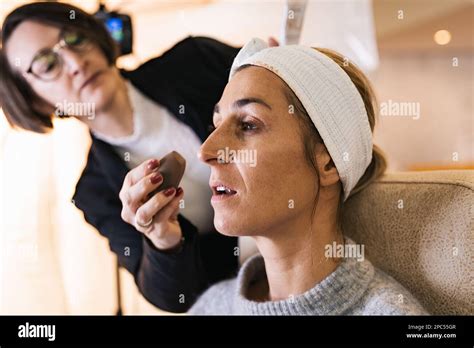 Make Up Assistant Applying Make Up With Makeup Sponge To Face Of A Model For A Photoshoot On