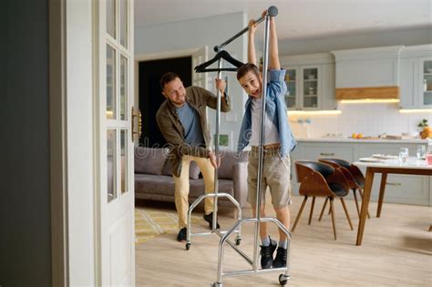 Father And Son Having Fun With Clothes Hanger Stock Image Image Of