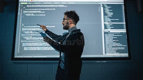 Teacher Giving Computer Science Lecture To Diverse Multiethnic Group Of