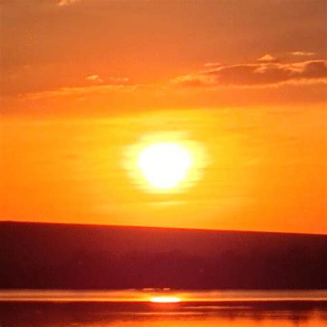 Premium Photo A Bright Orange Sunset With A Few Clouds In The Sky