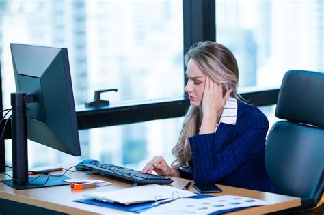 Premium Photo Businesswoman With Headache Using Computer On Desk In Office