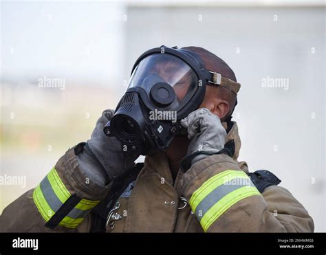 A Cadet Puts On His Firefighting Gear Before Entering The Simulated