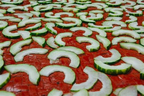 Premium Photo Chopped Cucumber Slices On Red Table