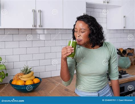 A Young Multiracial Woman Forces Herself To Drink A Nasty Tasting Green