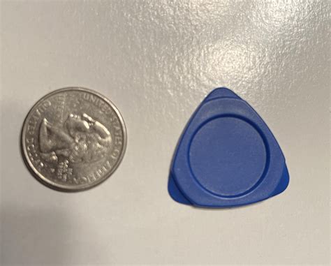 Blue Plastic Triangle With Raised Area Surrounding The Center Came