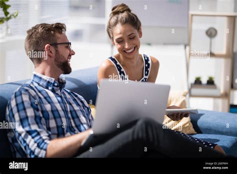 Portrait of executives interacting with each other while working together in the office Stock ...