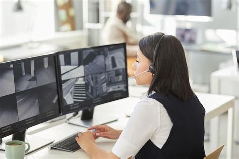Premium Photo Young Woman Looking At Surveillance Camera Feeds In