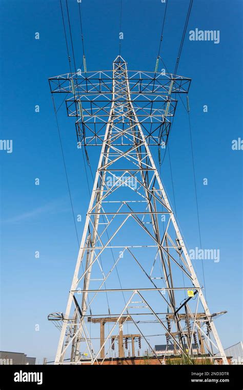Tall Electricity Pylon For Carrying Electricity Against Blue Sky Stock