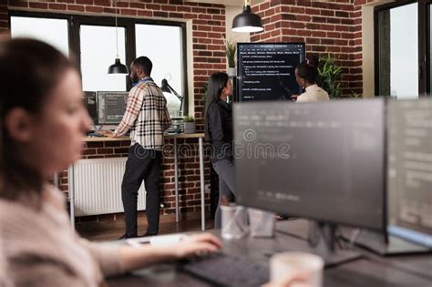 Diverse Tech Enginners Analyzing Machine Learning App Code Stock Image