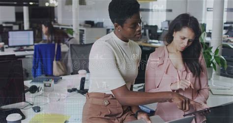 Animation Of Graphs Symbols Over Multiracial Female Coworkers Discussing Ideas Over Digital