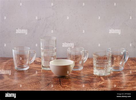 Empty Glasses And Cups Of Different Forms And Shapes On Wooden Tabletop