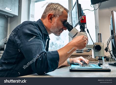 Male Engineer Looks Microcircuit Through Microscopedevelopment Stock