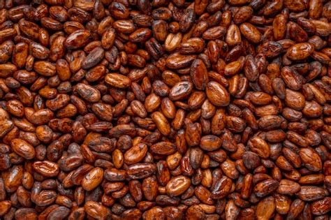 Premium Photo Cocoa Beans On Wooden Plate Aromatic Roasted Cocoa Beans In Wooden Background