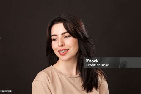 Studio Portrait Of A Cheerful 20 Year Old White Woman With Black Hair
