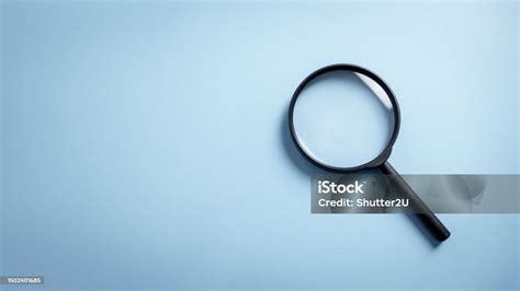 흰색 파란색 파스텔 배경에 빈 렌즈 검은색 돋보기가 있습니다 편평한 위치 목표와 검사는 과학 장비 공구 개념을 조사합니다 경찰