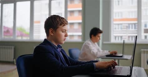 Caucasian Pupils Boys Working With Laptops In Computer Based Class Web